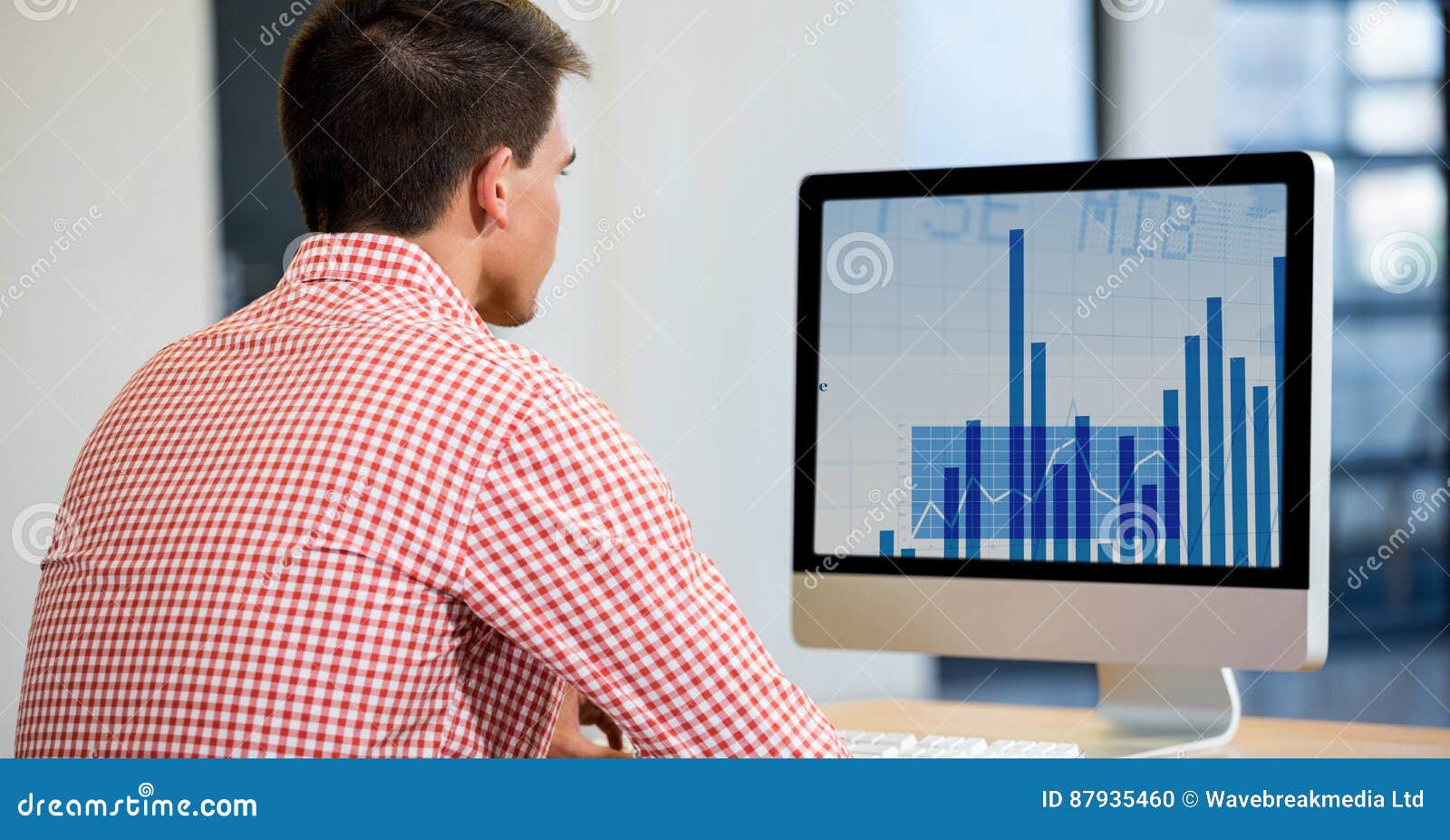 Man Using Desktop Computer Displaying a Graph Chart on Screen Stock ...