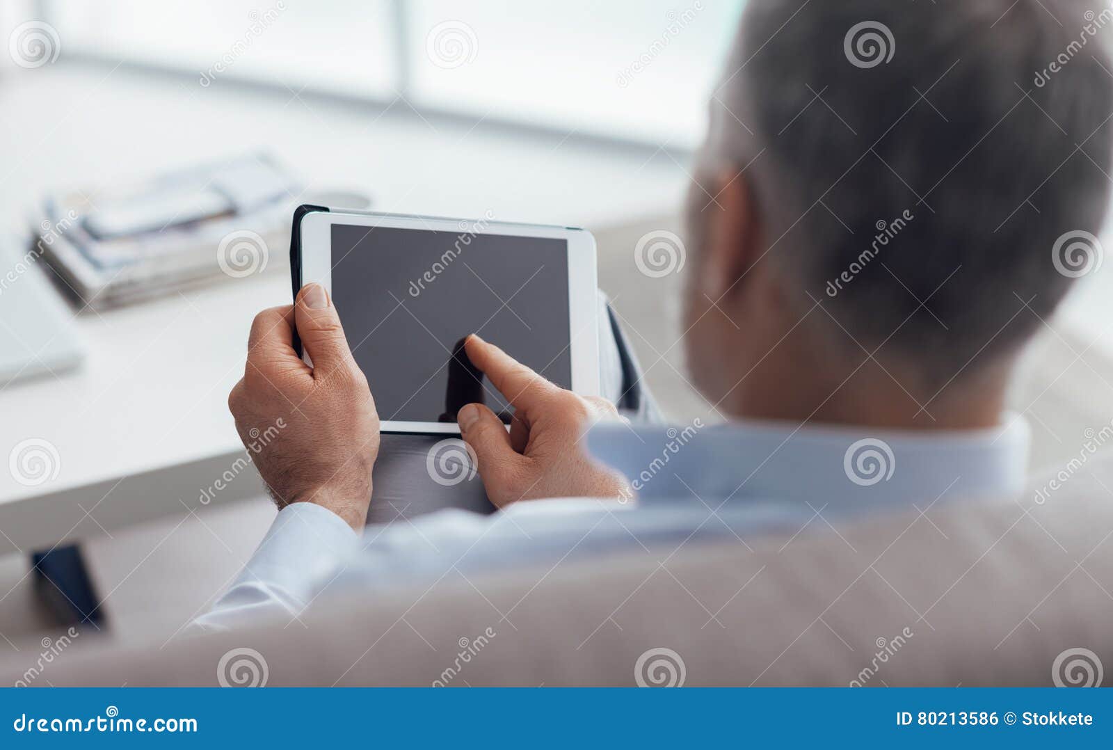 Man using a digital tablet stock photo. Image of living - 80213586