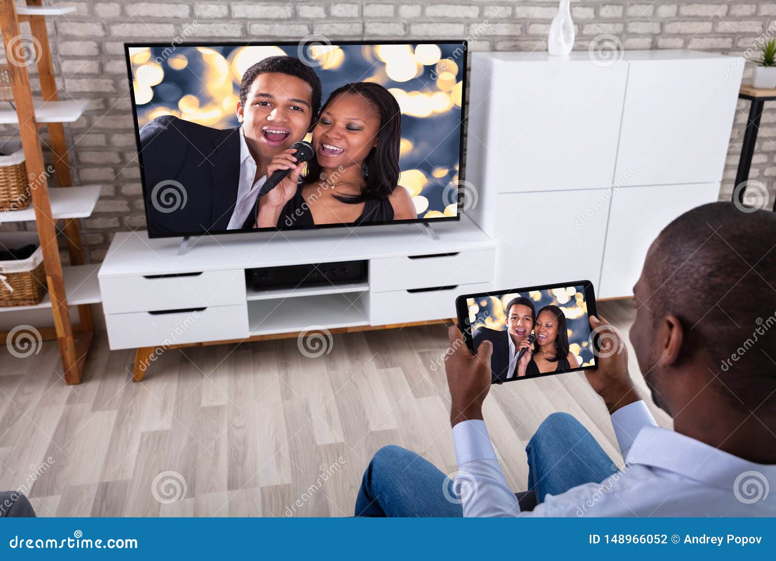 Man Using Digital Tablet while Watching Television Stock Photo - Image ...
