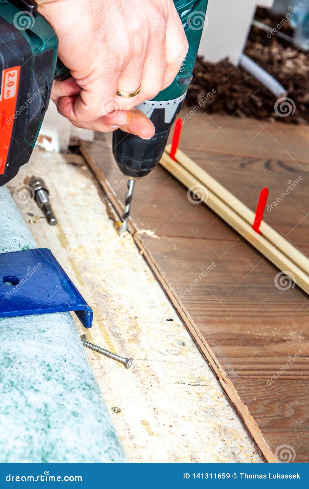 Man Using Drill Machine while Installing New Wooden Laminate Flooring ...