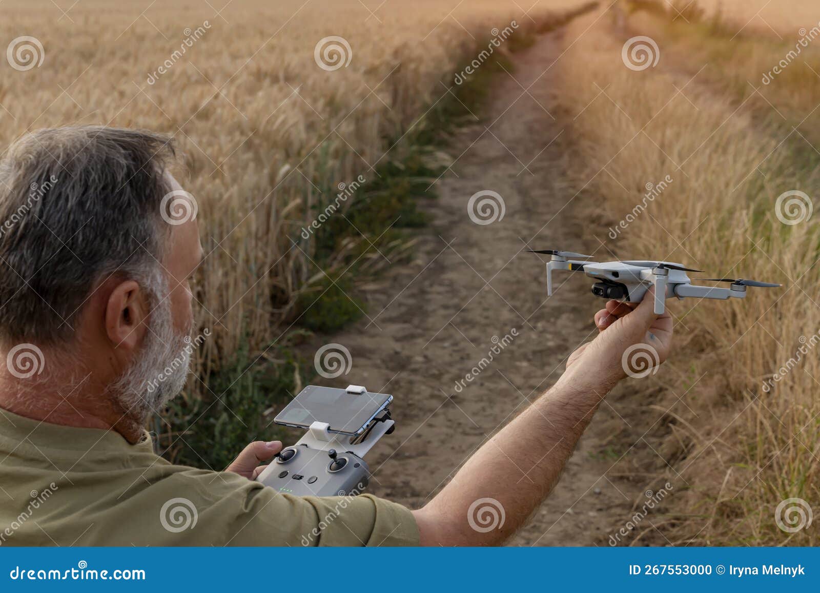 Man Using a Drone with Remote Controller Making Photos and Videos ...