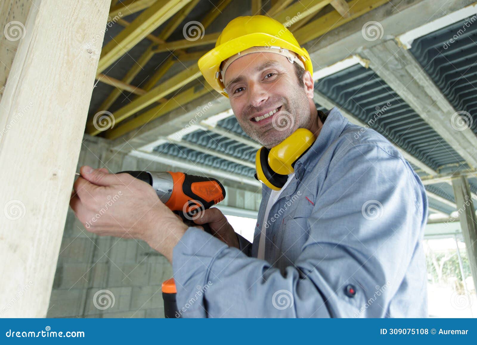 Man using electric drill stock photo. Image of safety - 309075108