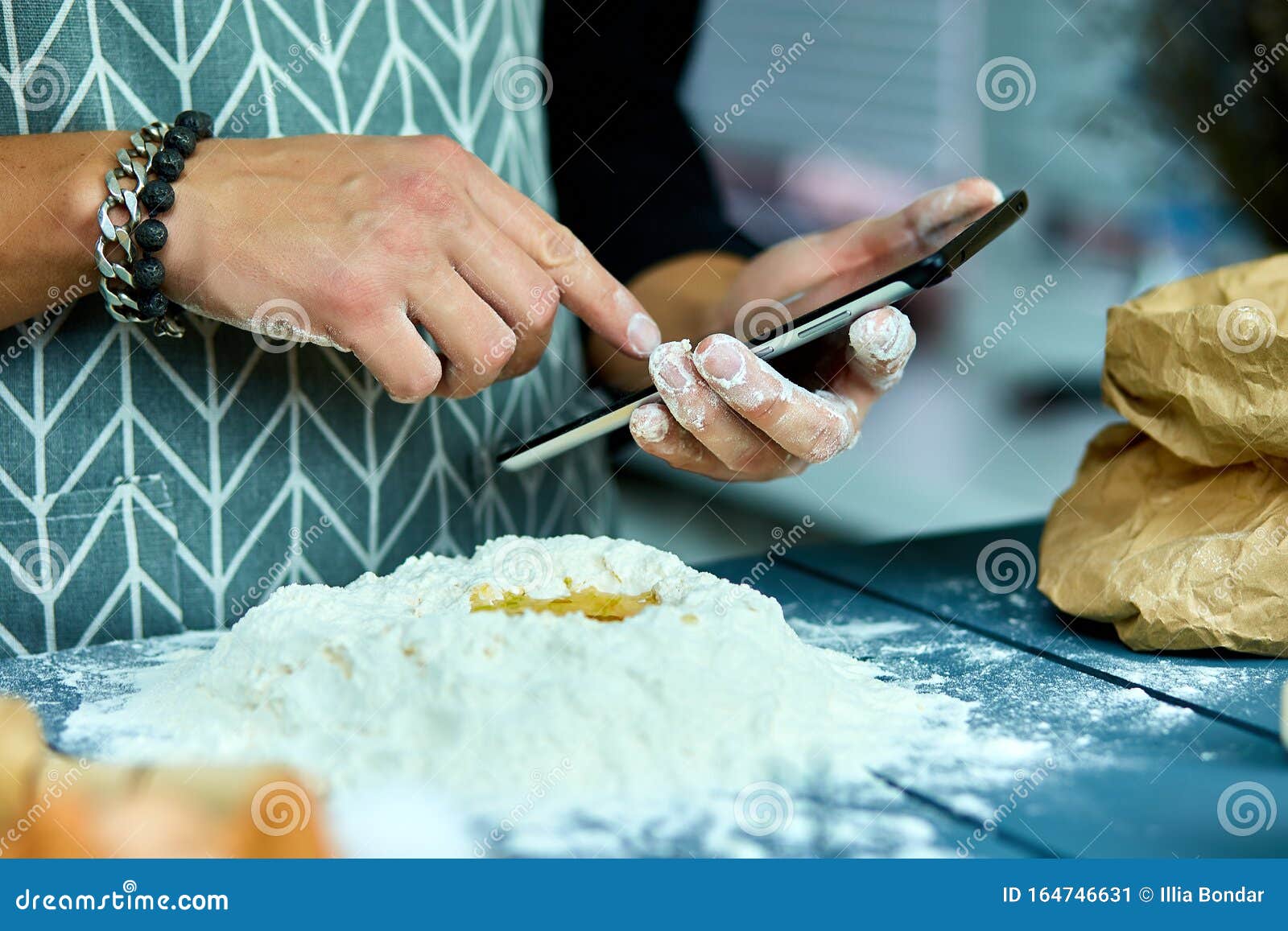 Man Using Electronic Tablet Pc in Kitchen for Baking. Man Searching for ...