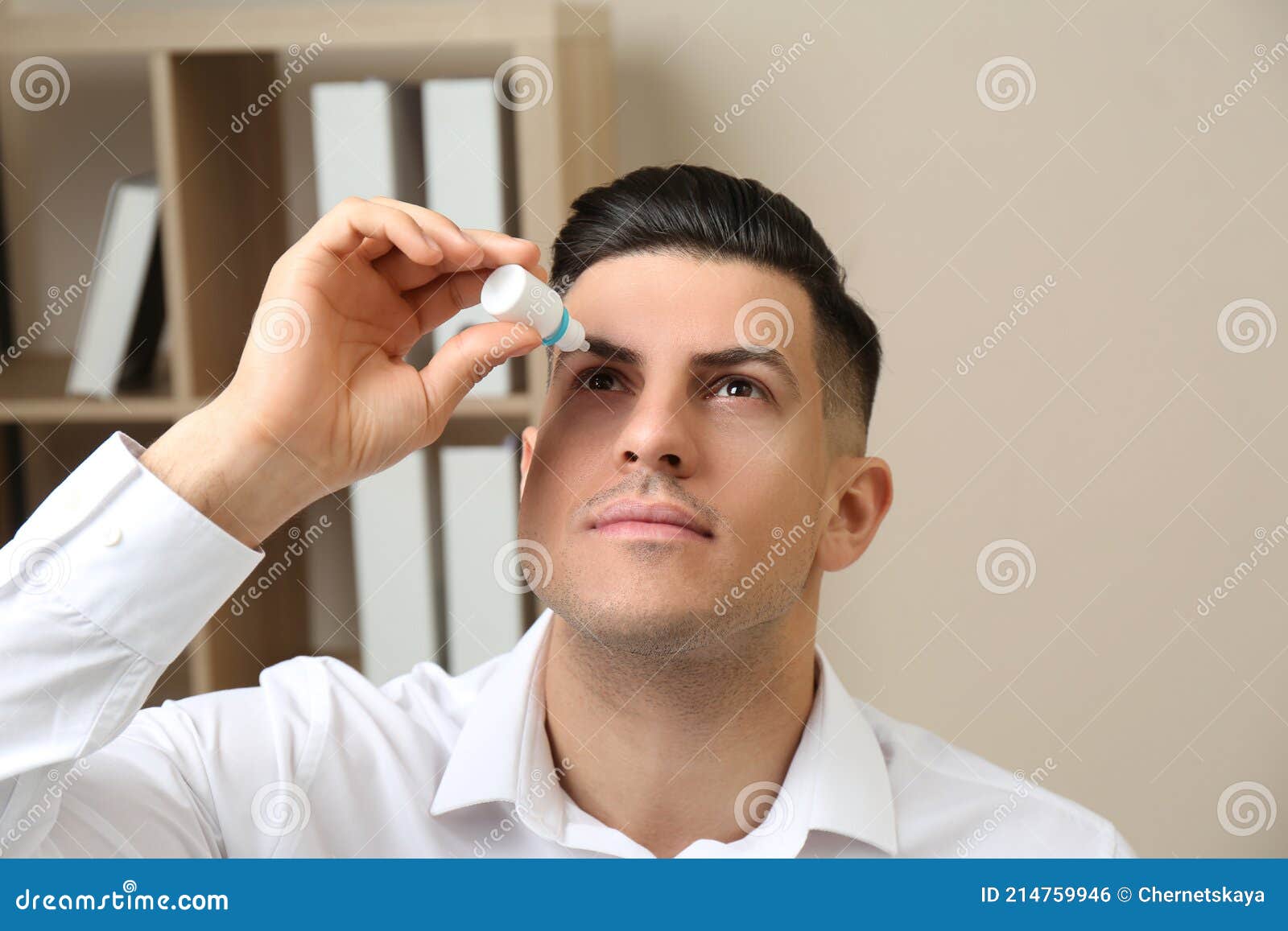 Man Using Eye Drops in Light Office Stock Photo - Image of drop ...