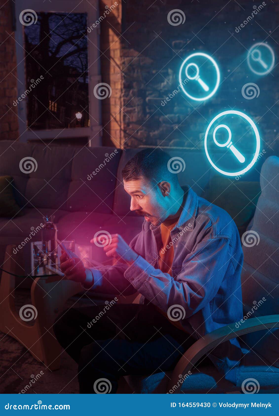 Man Using Gadget and Receive Neon Notifications at Home at Night Stock ...