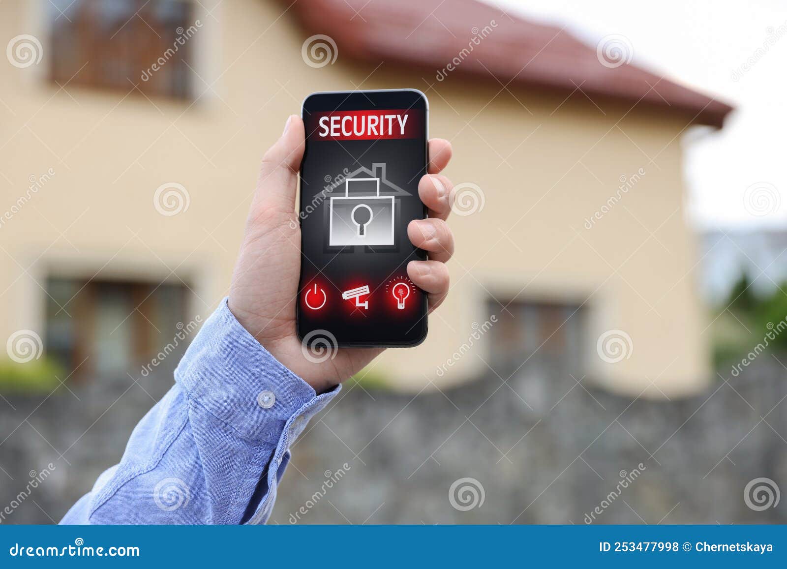 Man Using Home Security Application on Smartphone in Front of House ...