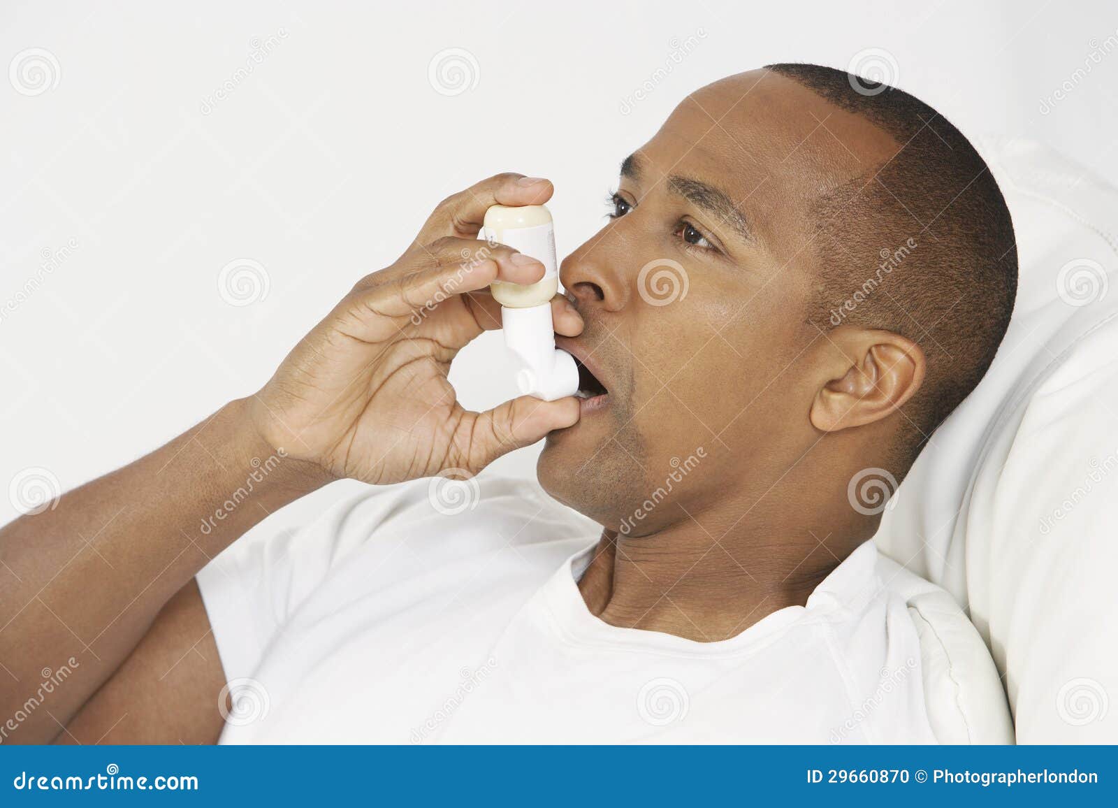 Man Using Inhaler in Bed stock photo. Image of tshirt - 29660870