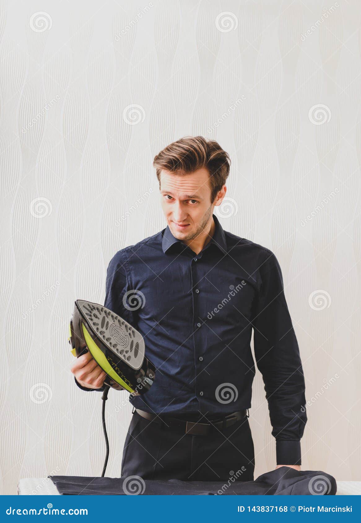 Man using iron in home stock photo. Image of household - 143837168