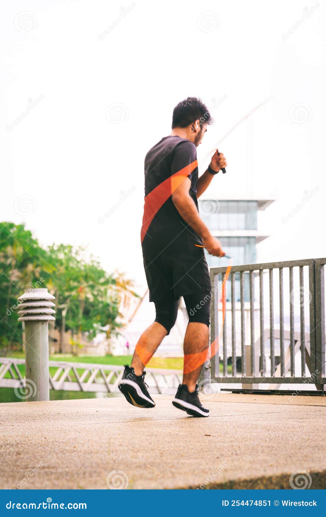 Man Using Jumping Rope Outdoors. View from Behind. Stock Image - Image ...