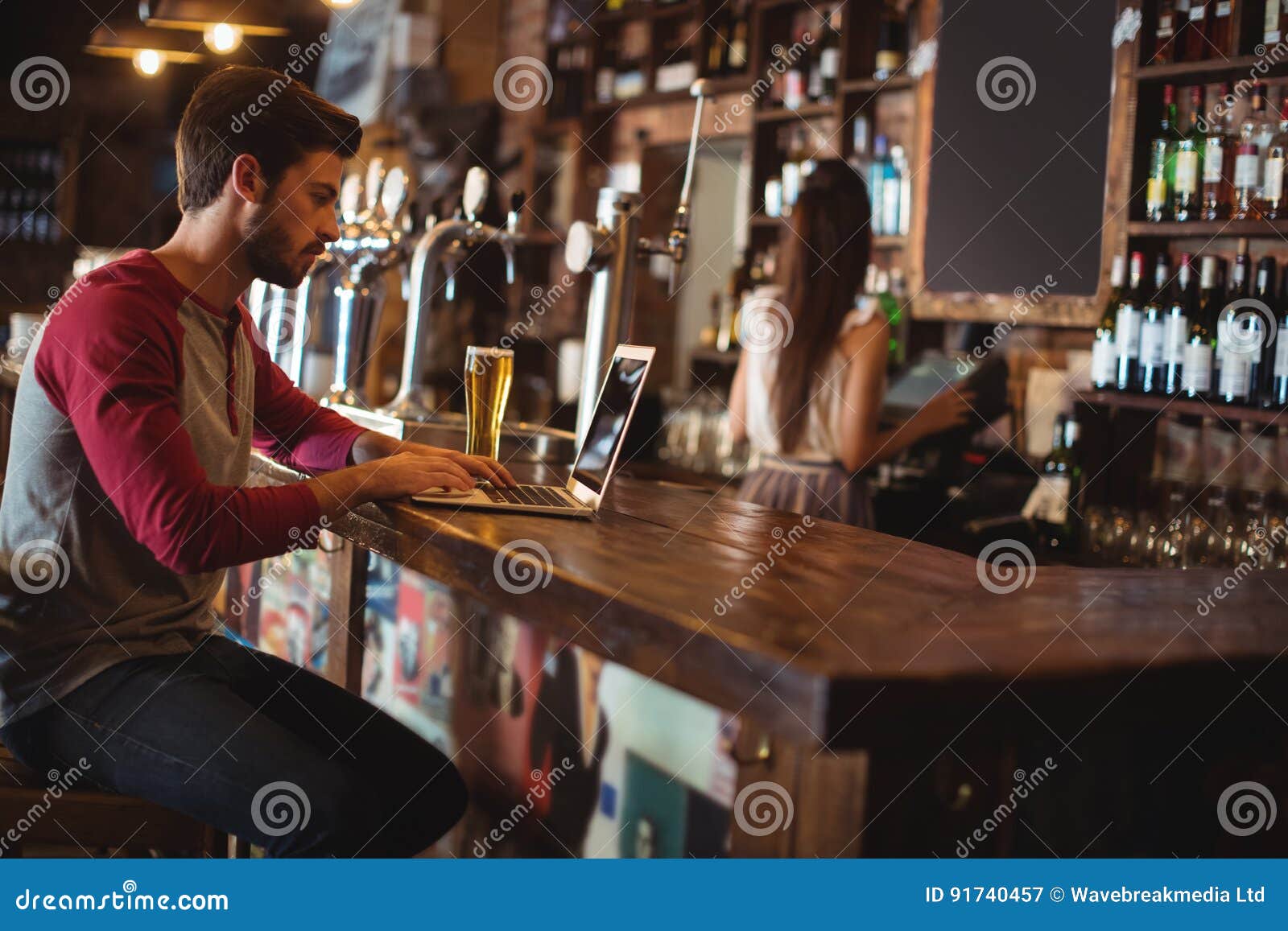Man using laptop stock image. Image of beer, food, beverage - 91740457