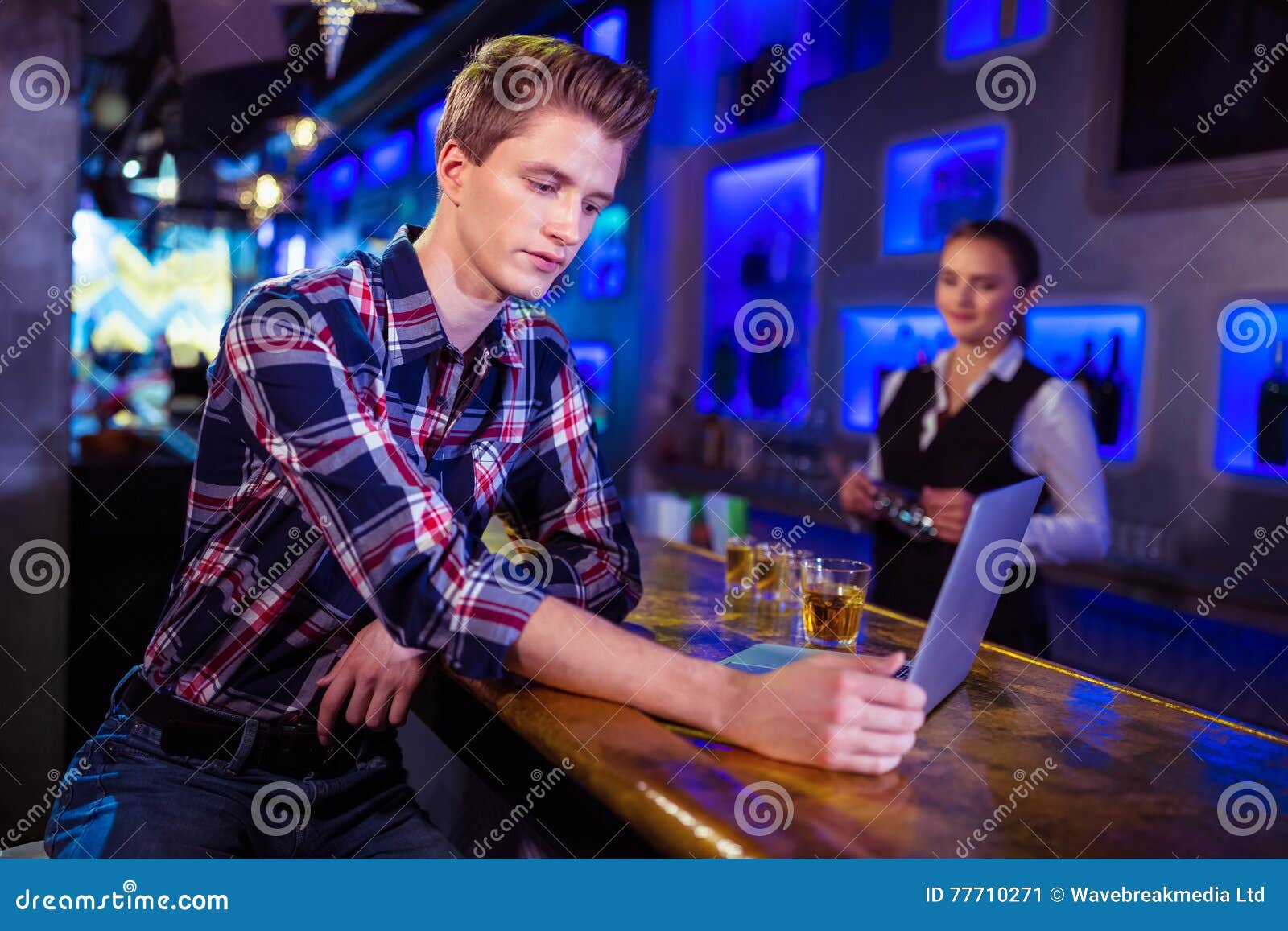 Man Using Laptop at Bar Counter with Bartender Working Stock Image ...