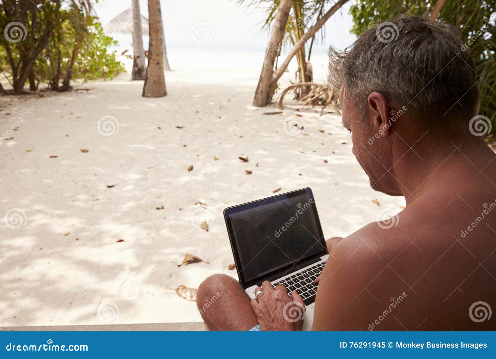 Man Using a Laptop Computer on a Beach, Over Shoulder View Stock Image ...