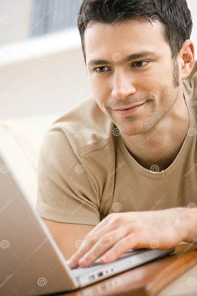 Man Using Laptop Computer at Home Stock Photo - Image of good, browsing ...