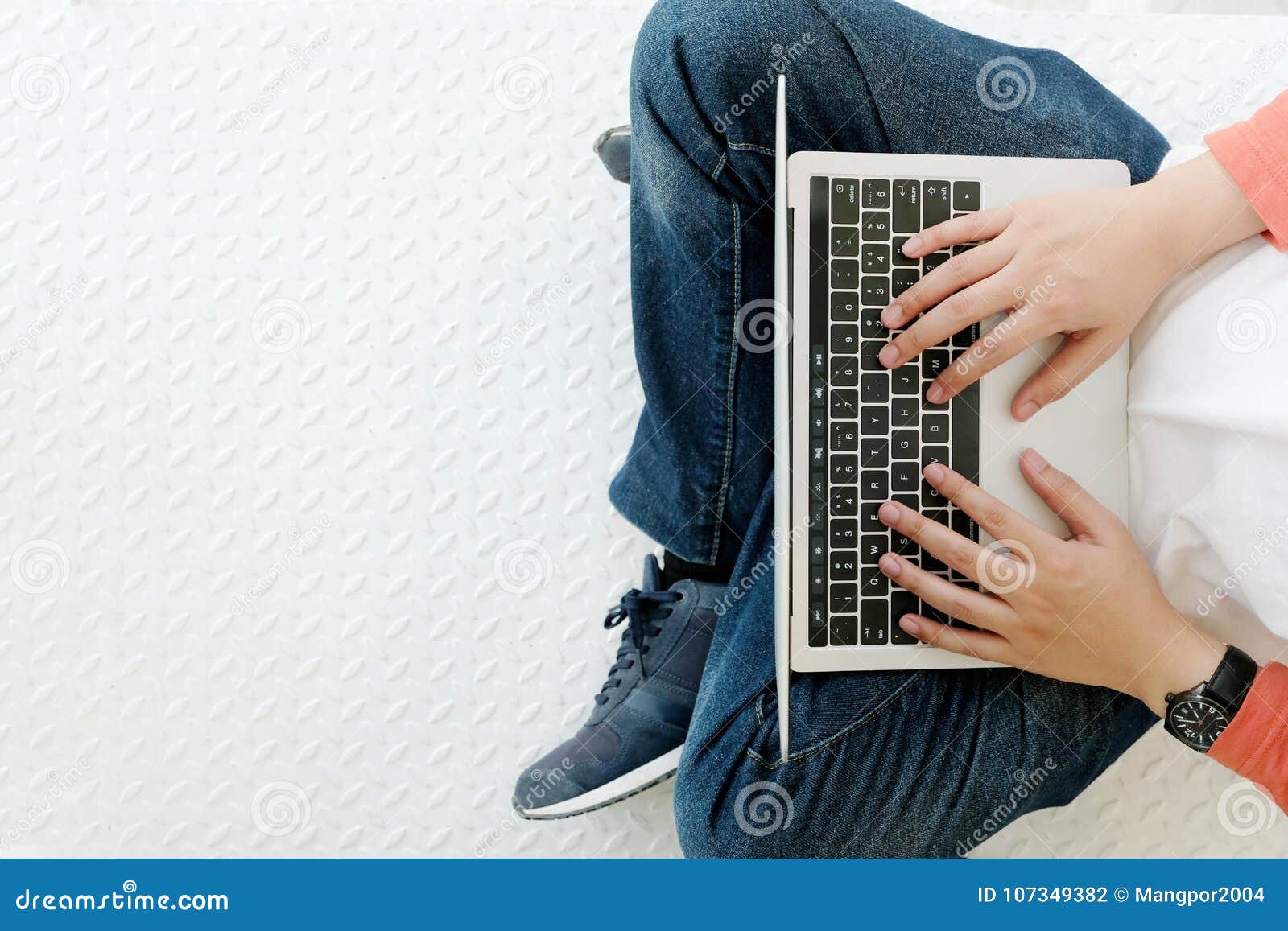 Man Using Laptop Computer while Sitting on White Floor Background with ...