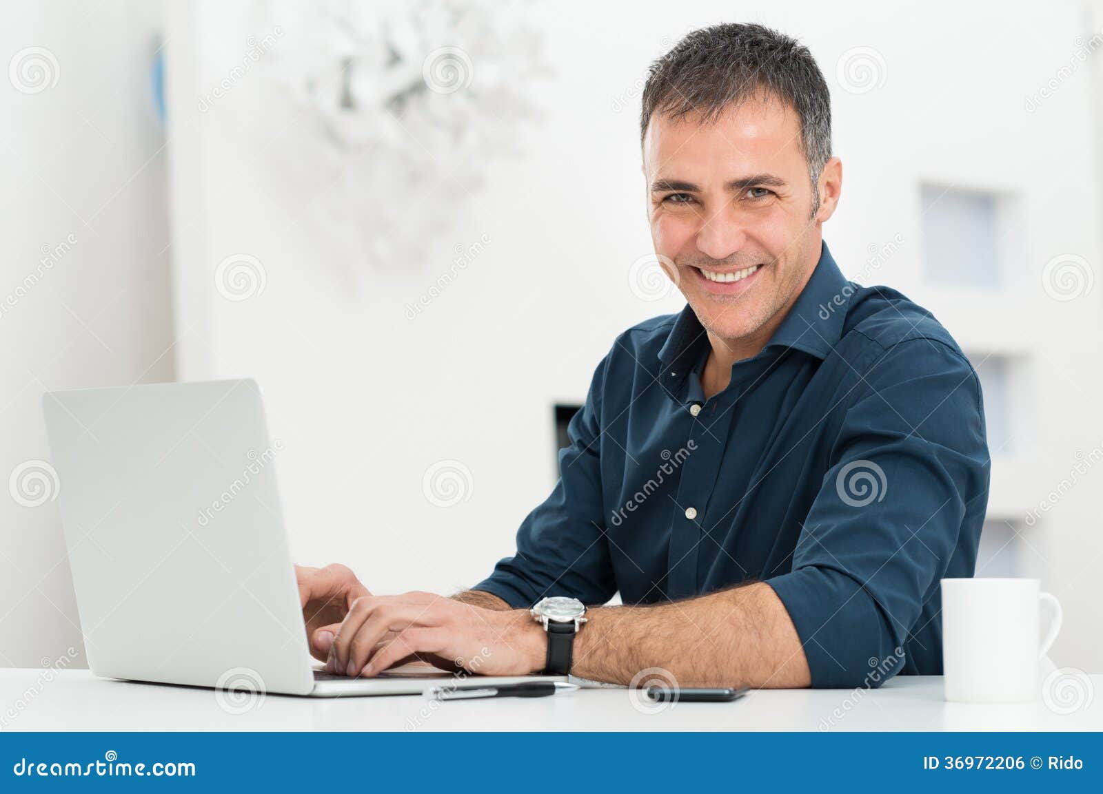 Man Using Laptop at Desk stock photo. Image of online - 36972206