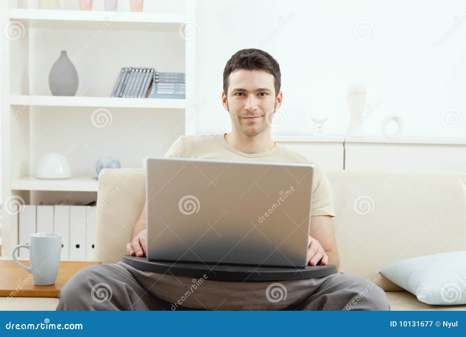 Man using laptop at home stock image. Image of apartment - 10131677