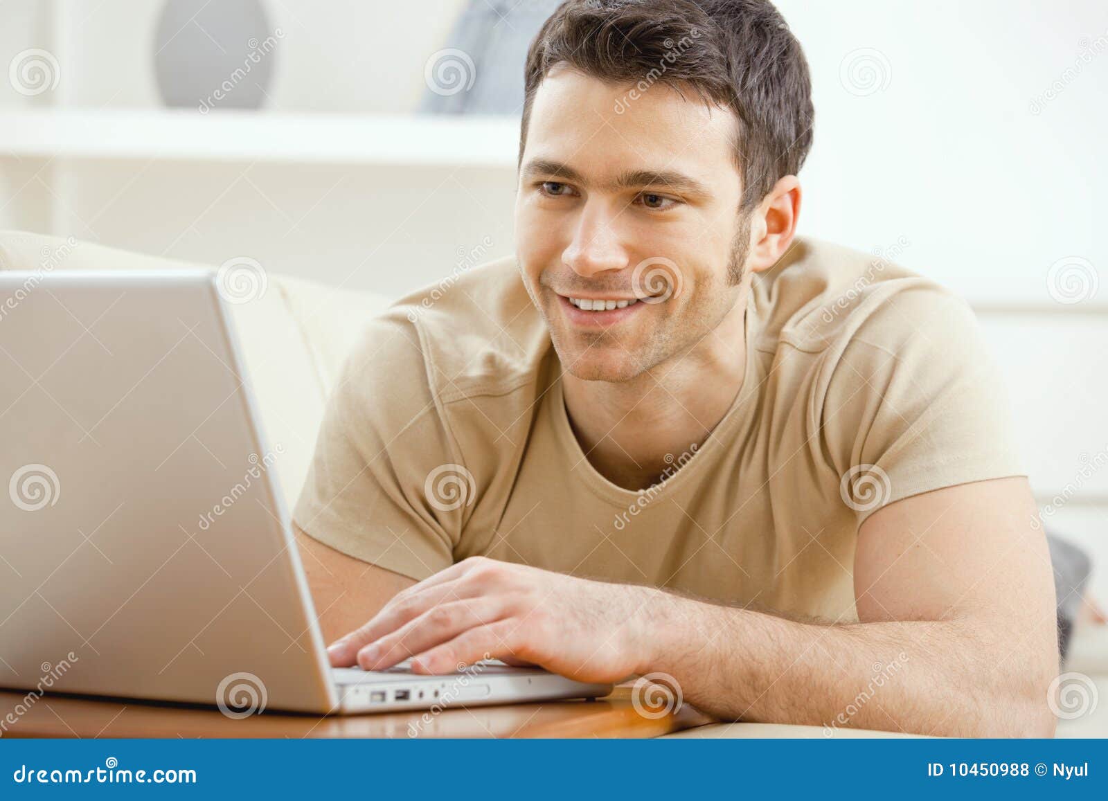Man using laptop at home stock photo. Image of browsing - 10450988
