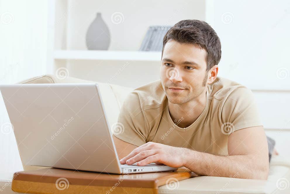 Man using laptop at home stock image. Image of happy - 11413321
