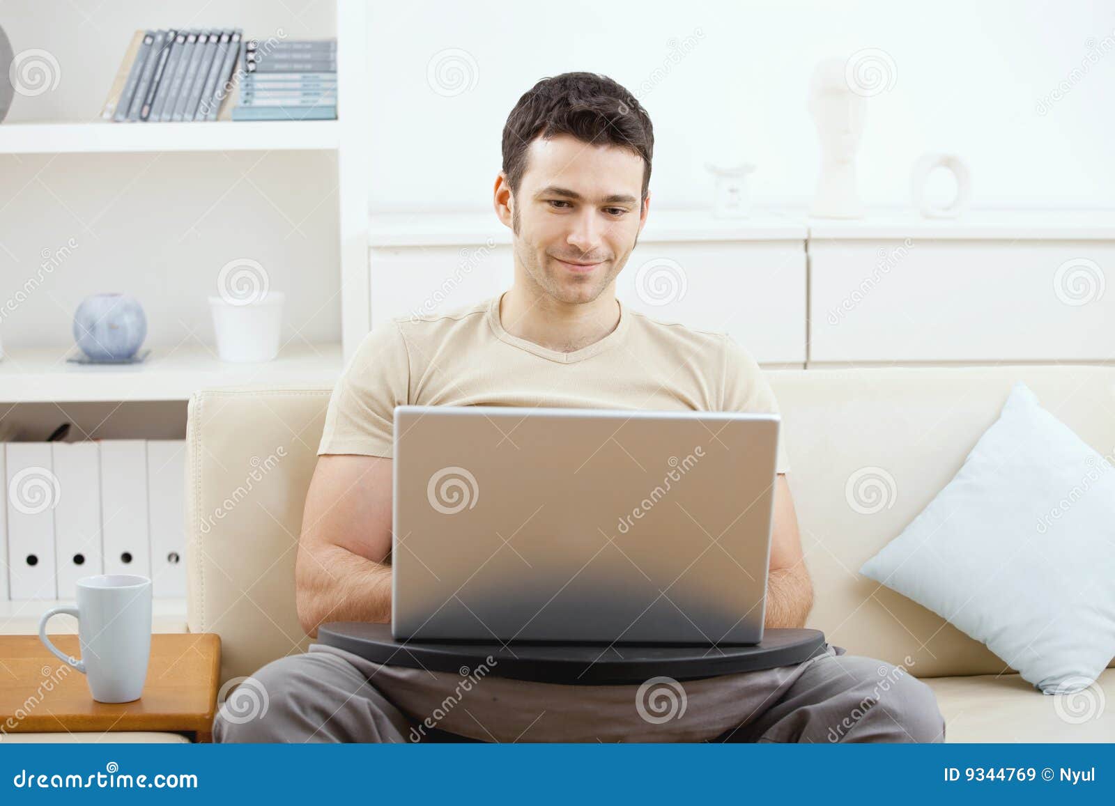 Man using laptop at home stock image. Image of indoors - 9344769