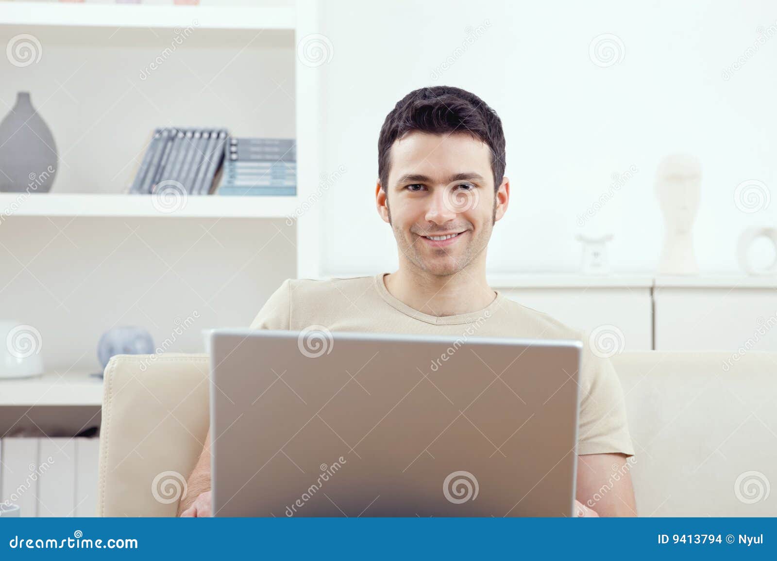 Man using laptop at home stock photo. Image of color, apartment - 9413794