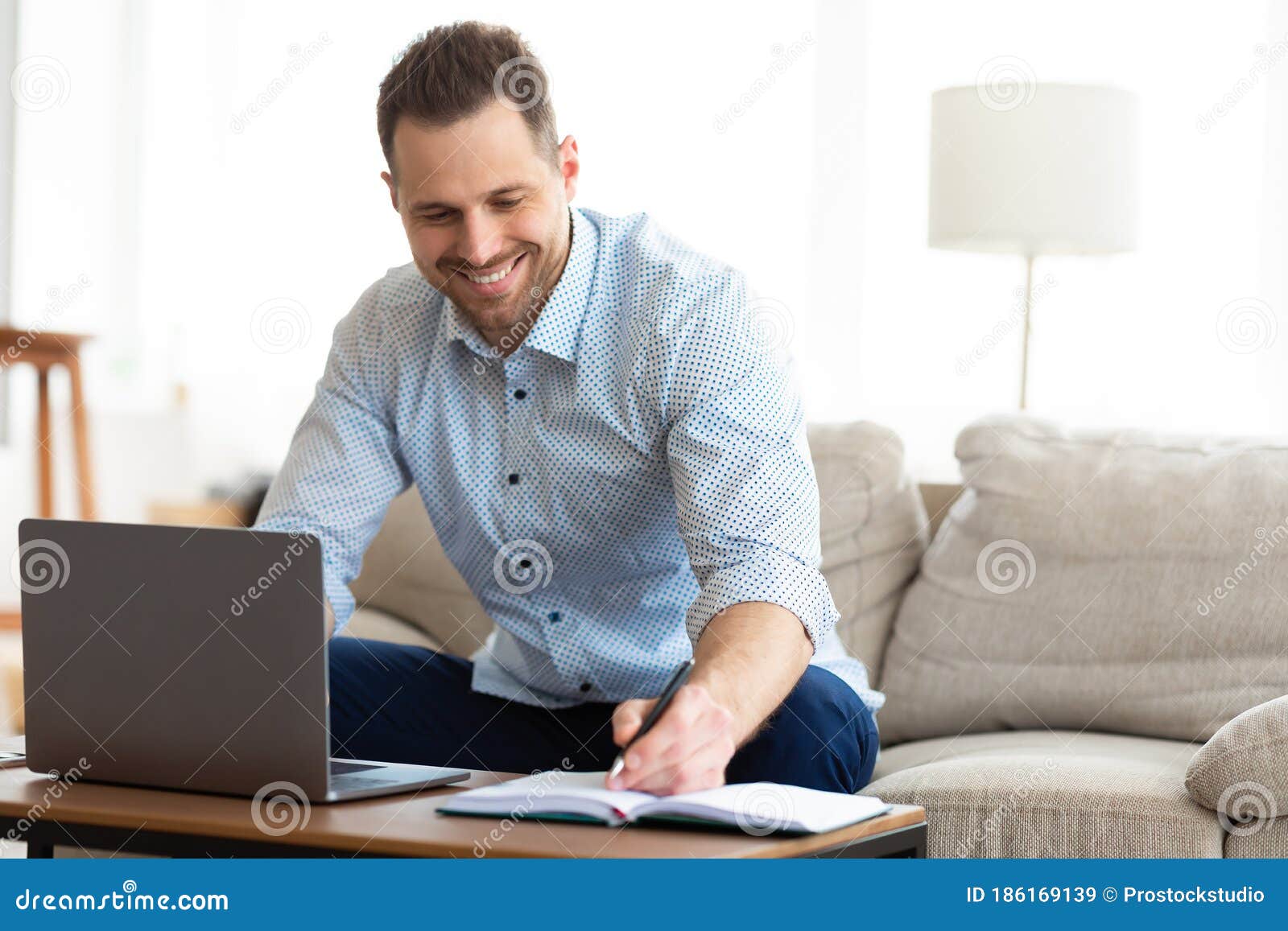 Man Using Laptop at Home and Writing Notes Stock Image - Image of ...