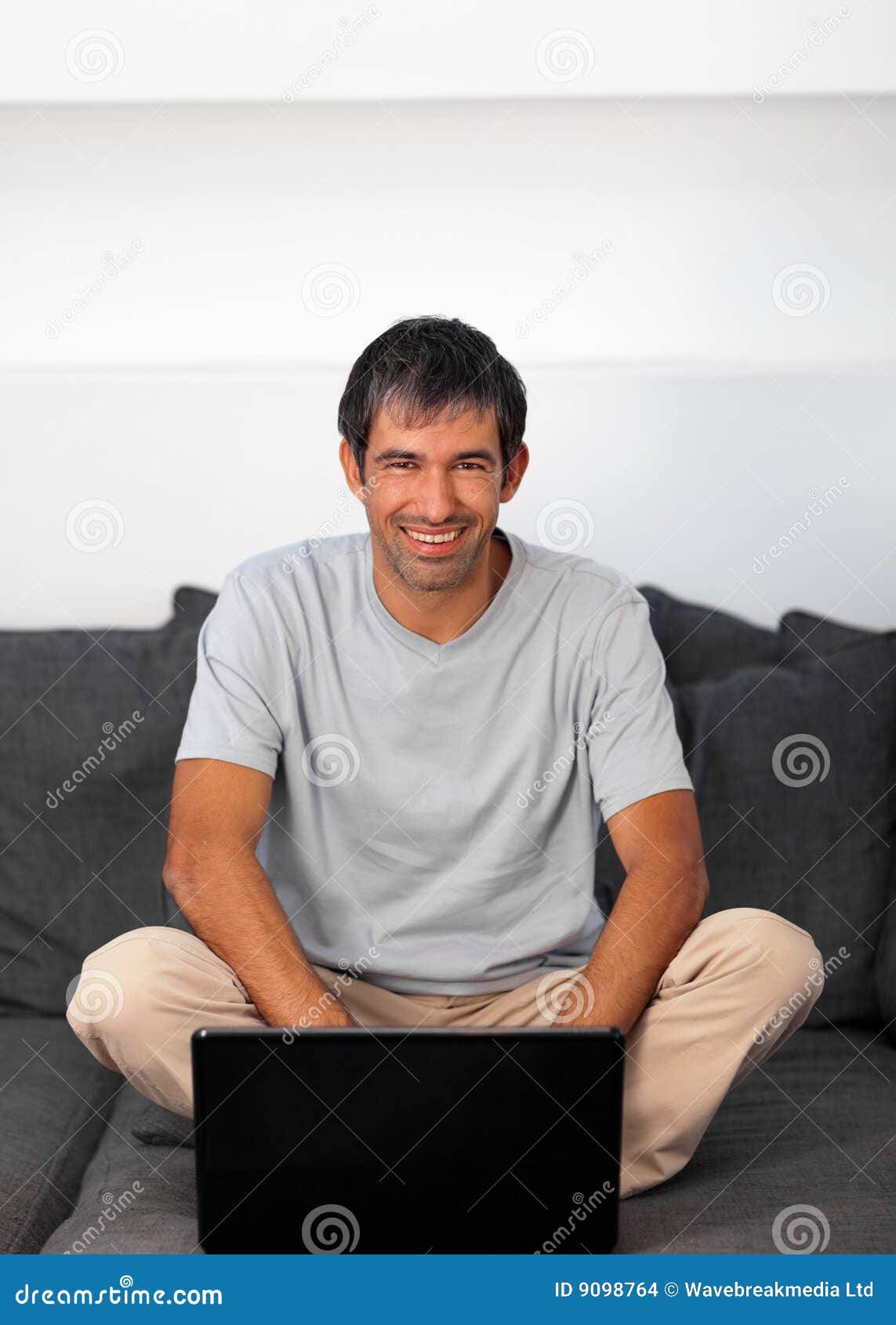 Man Using Laptop Looking at Camera Stock Photo - Image of interior ...