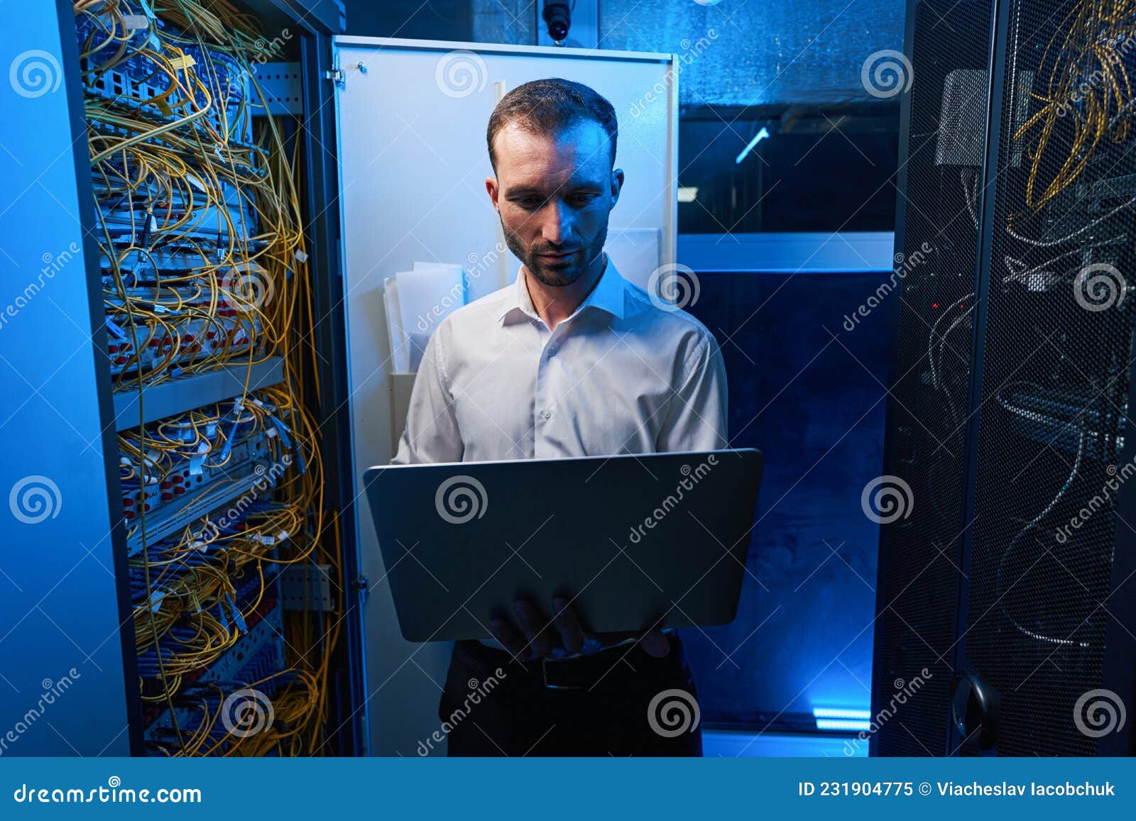 Man Using Laptop Near Open Server Cabinet Stock Image - Image of center ...