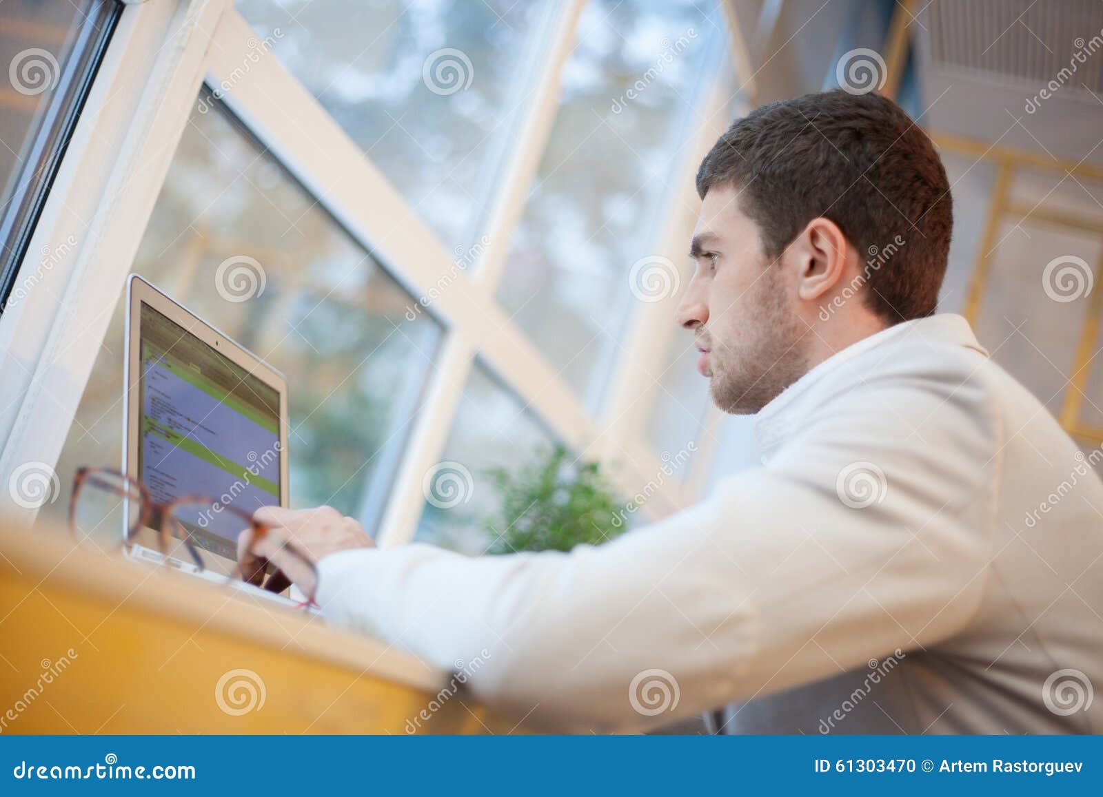 Man using laptop in office stock photo. Image of happy - 61303470