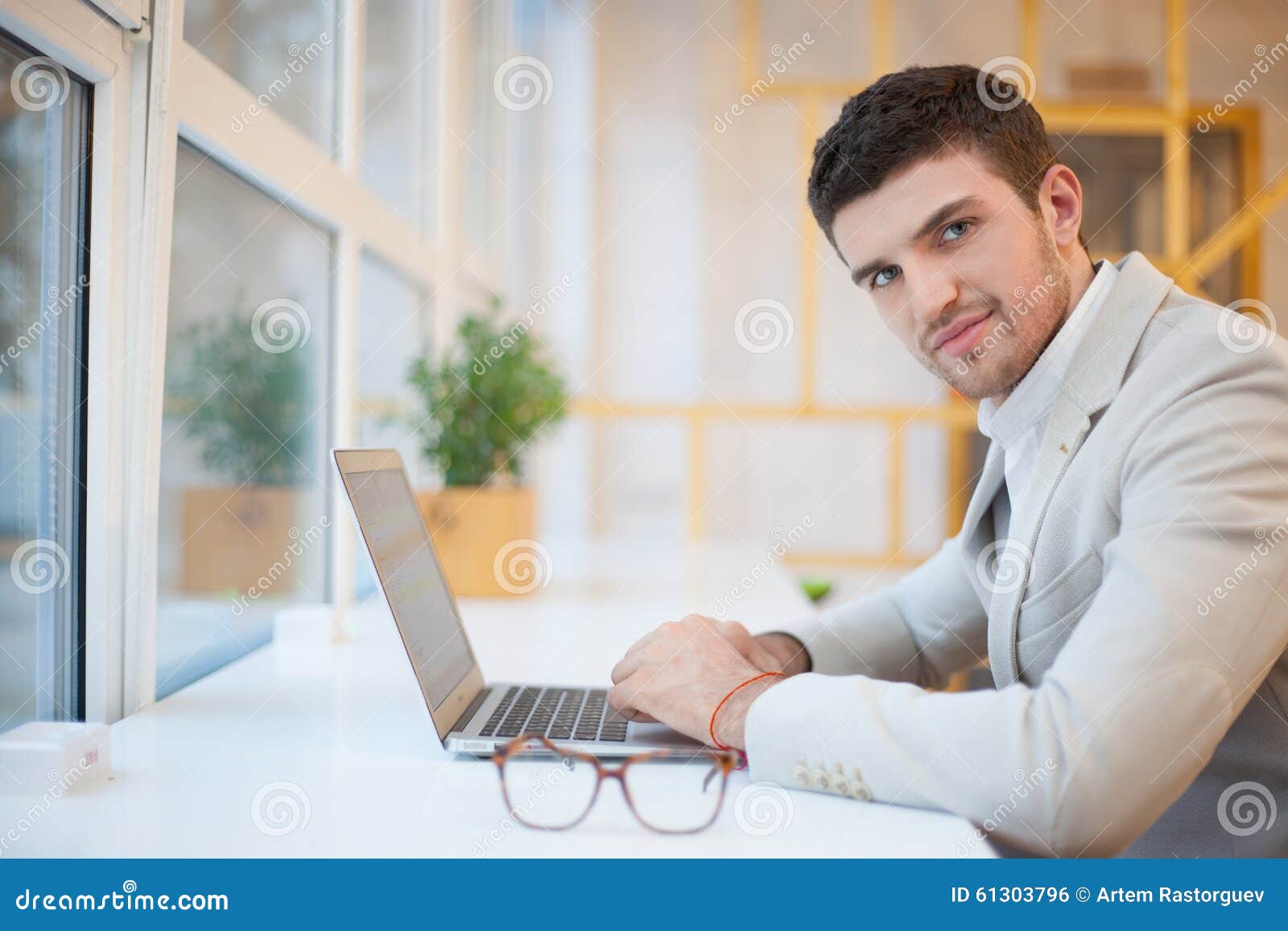 Man using laptop in office stock photo. Image of portrait - 61303796