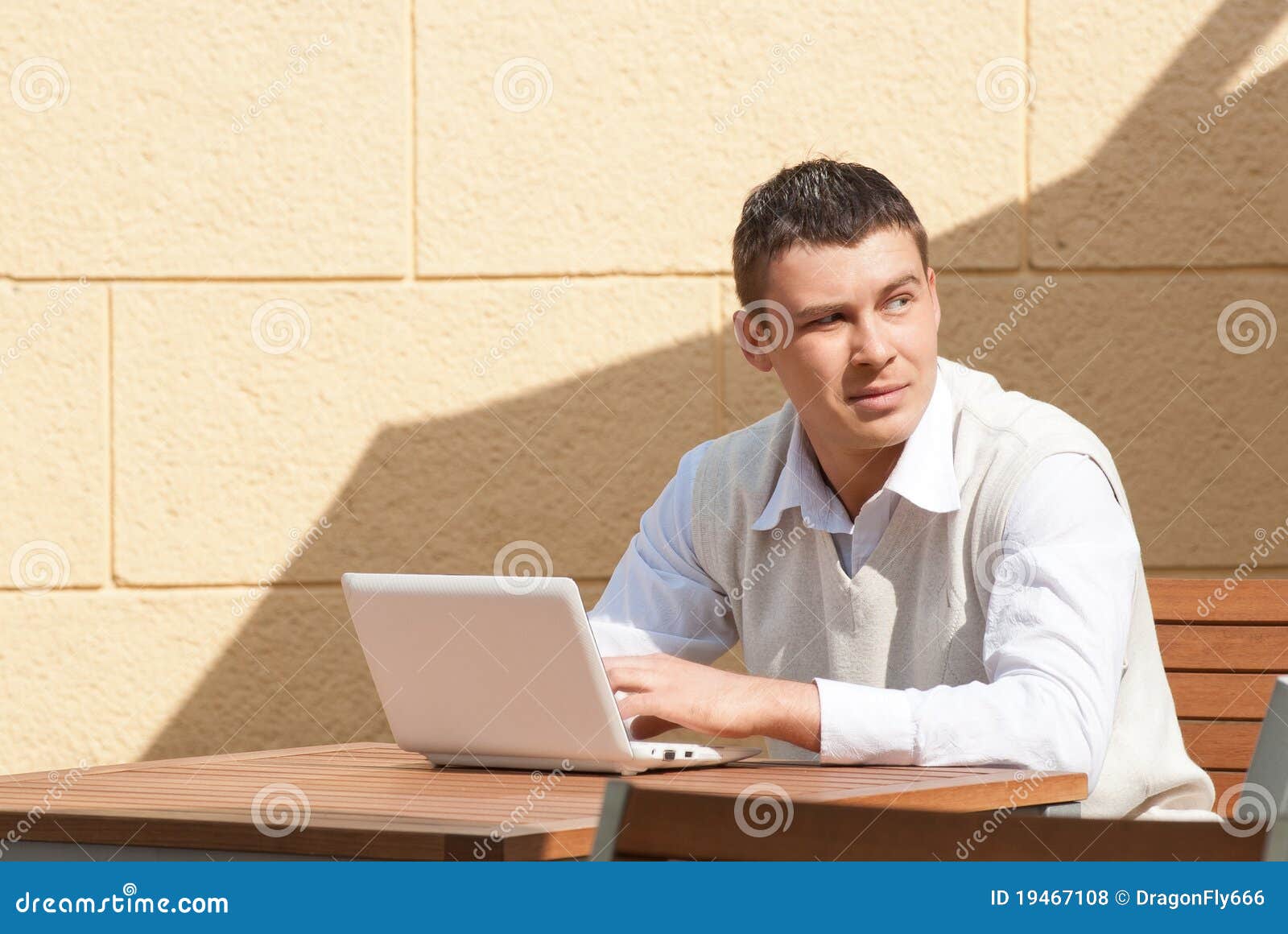 Man Using a Laptop Outdoors Stock Photo - Image of sitting, searching ...