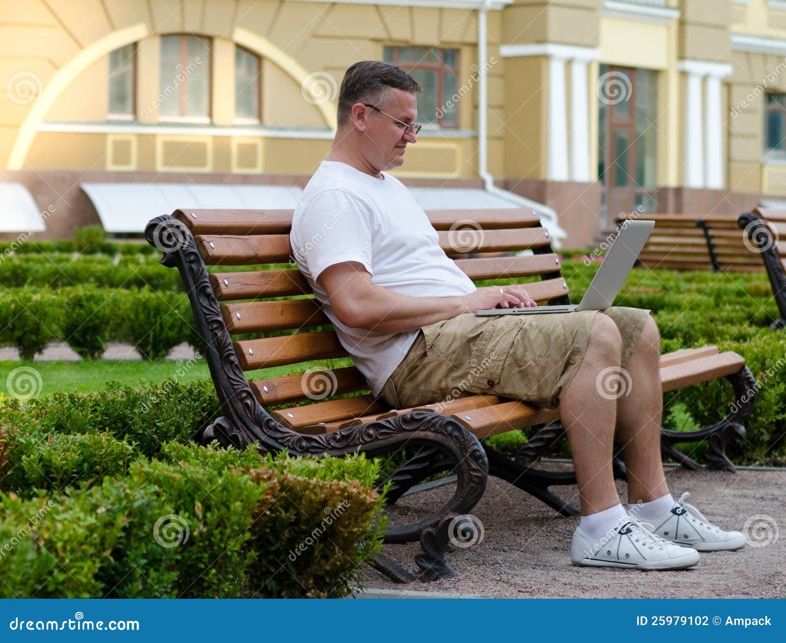 Man Using a Laptop on a Public Bench Stock Photo - Image of casual ...
