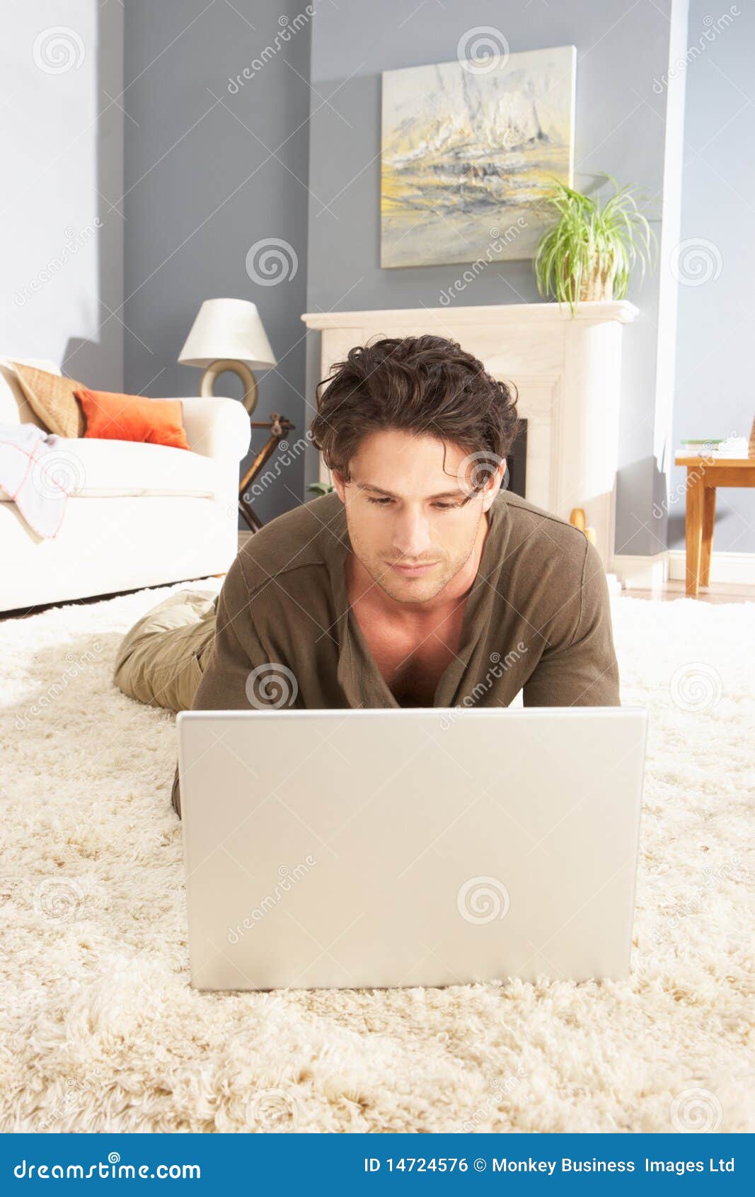 Man Using Laptop Relaxing Laying on Rug at Home Stock Photo - Image of ...