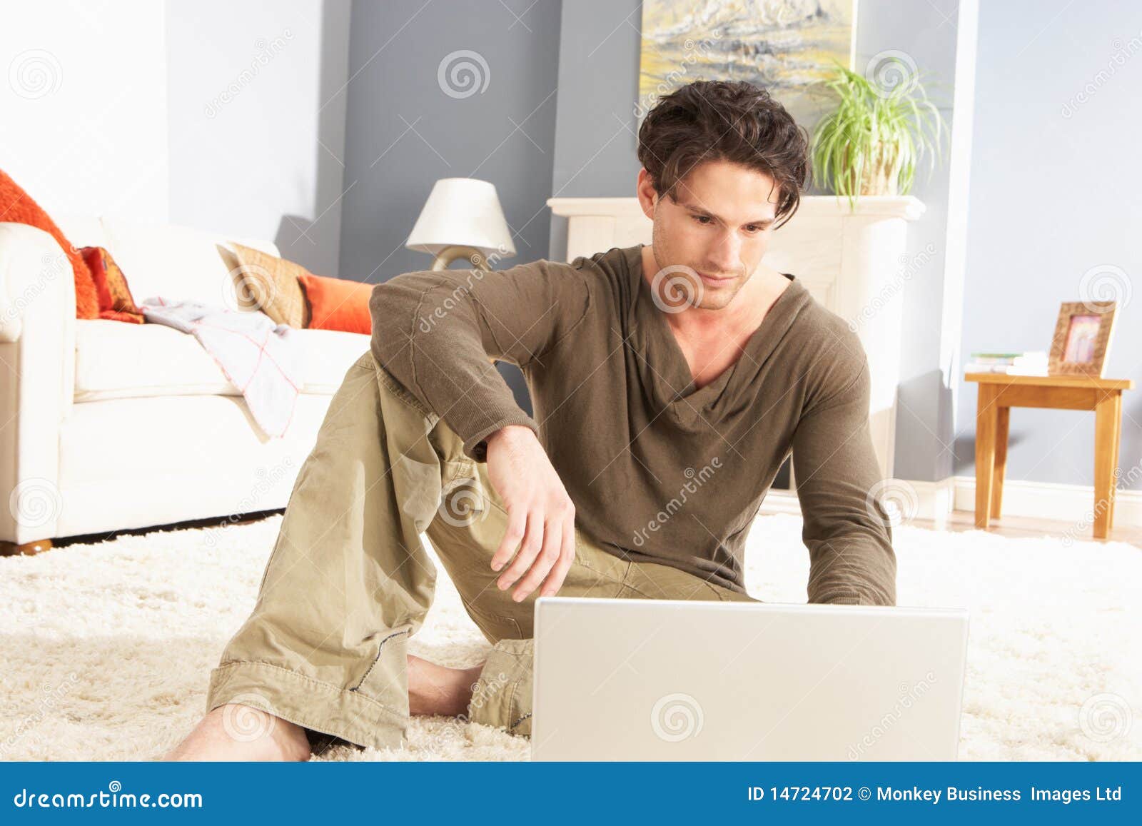 Man Using Laptop Relaxing Sitting on Rug at Home Stock Photo - Image of ...