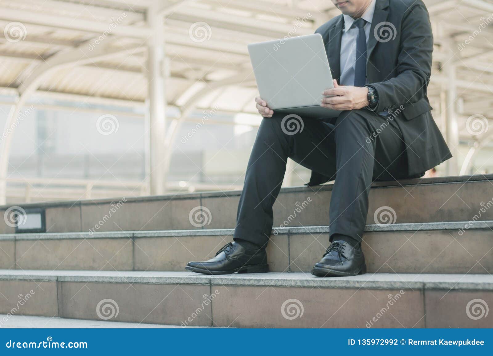 Man using laptop on stair stock photo. Image of lifestyle - 135972992