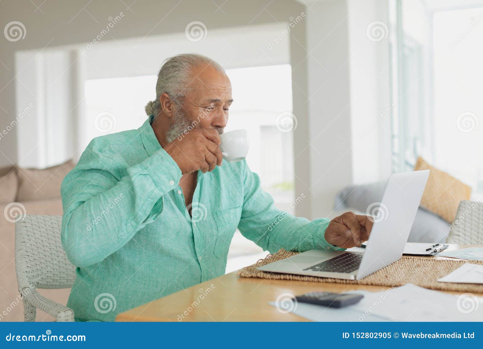 Man using laptop on table stock image. Image of bill - 152802905