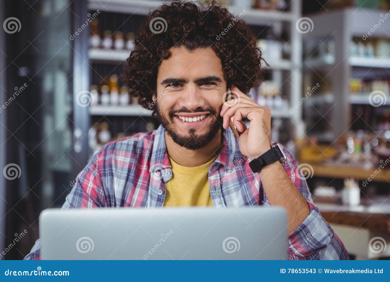 Man Using Laptop while Talking on Mobile Phone Stock Image - Image of ...