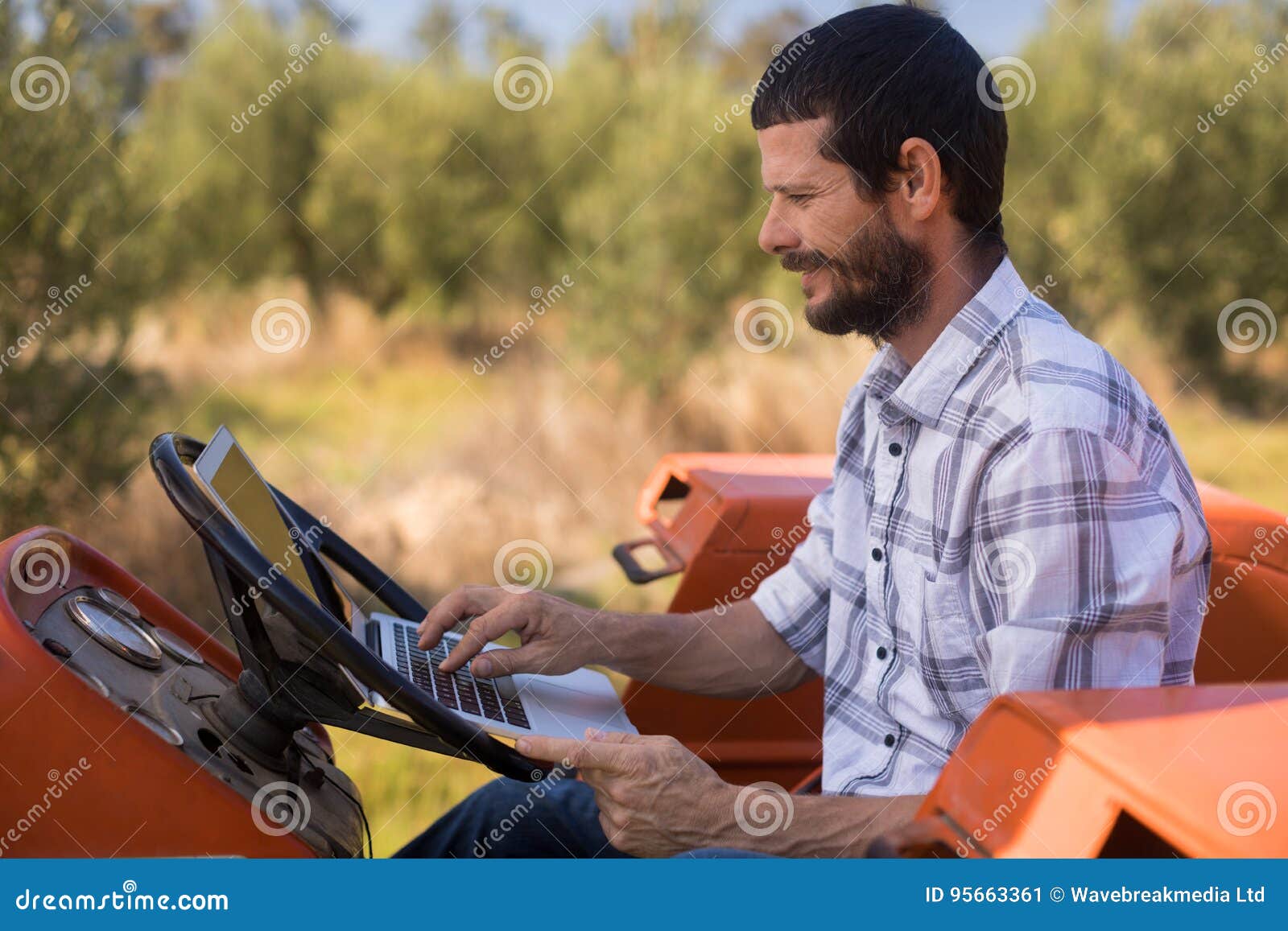 Man Using Laptop in Tractor Stock Image - Image of casual, nature: 95663361