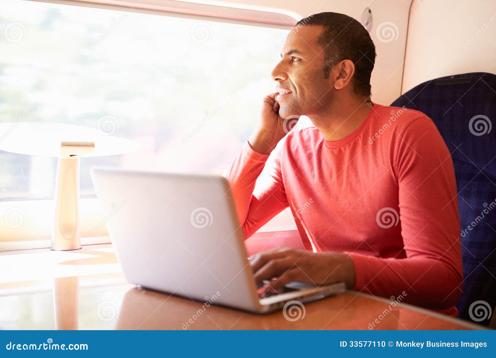 Man Using Laptop on Train stock photo. Image of railway - 33577110