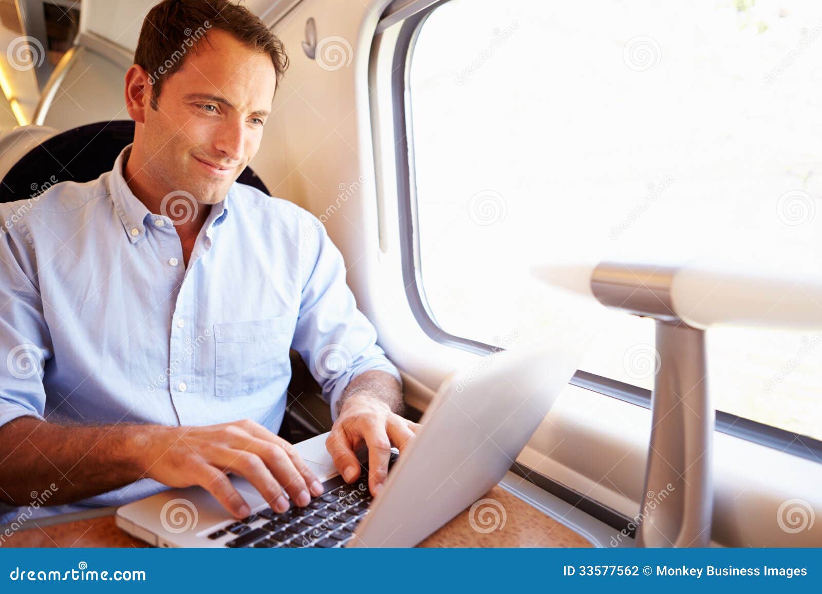 Man Using Laptop on Train stock photo. Image of journey - 33577562