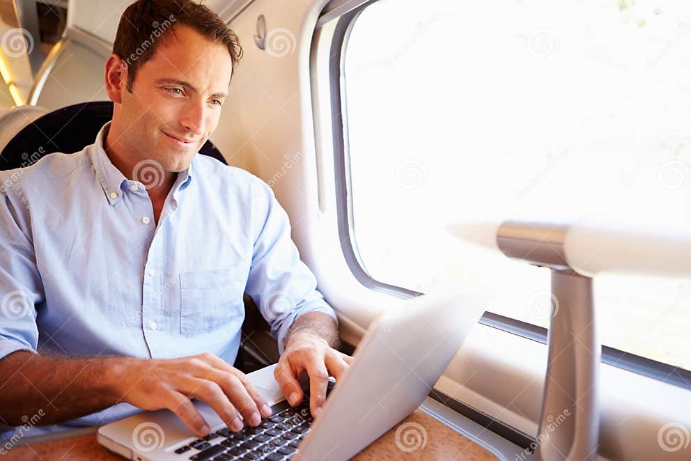 Man Using Laptop on Train stock photo. Image of journey - 33577562