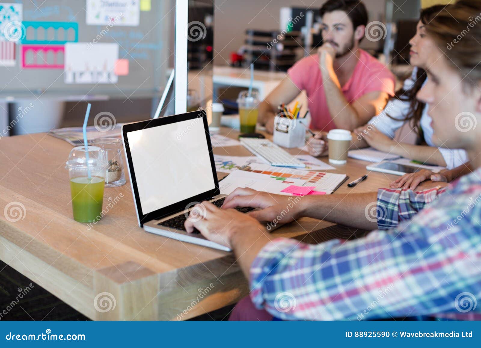 Man Using Laptop while Working with His Team Stock Photo - Image of ...