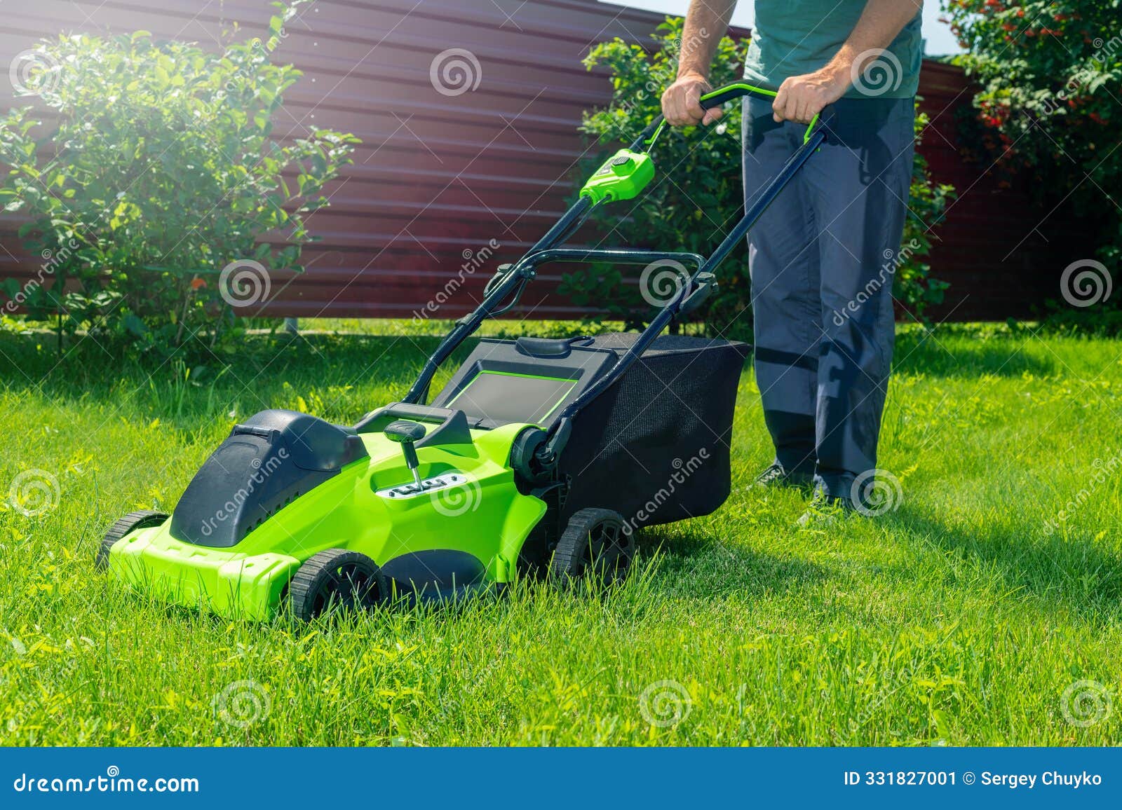 Man Using a Lawn Mower in Him Backyard at Summer Sunny Day Stock Image ...