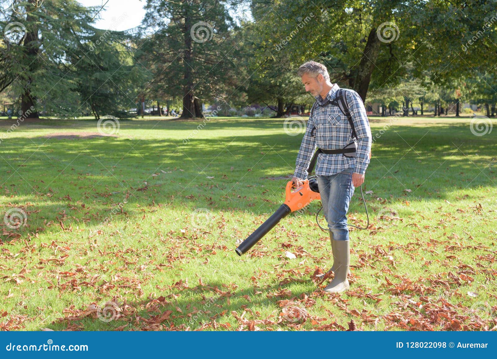 Man using leaf blower stock photo. Image of gardener - 128022098