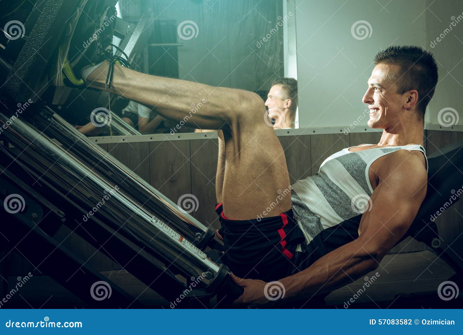 Man using leg press in gym stock photo. Image of physical - 57083582