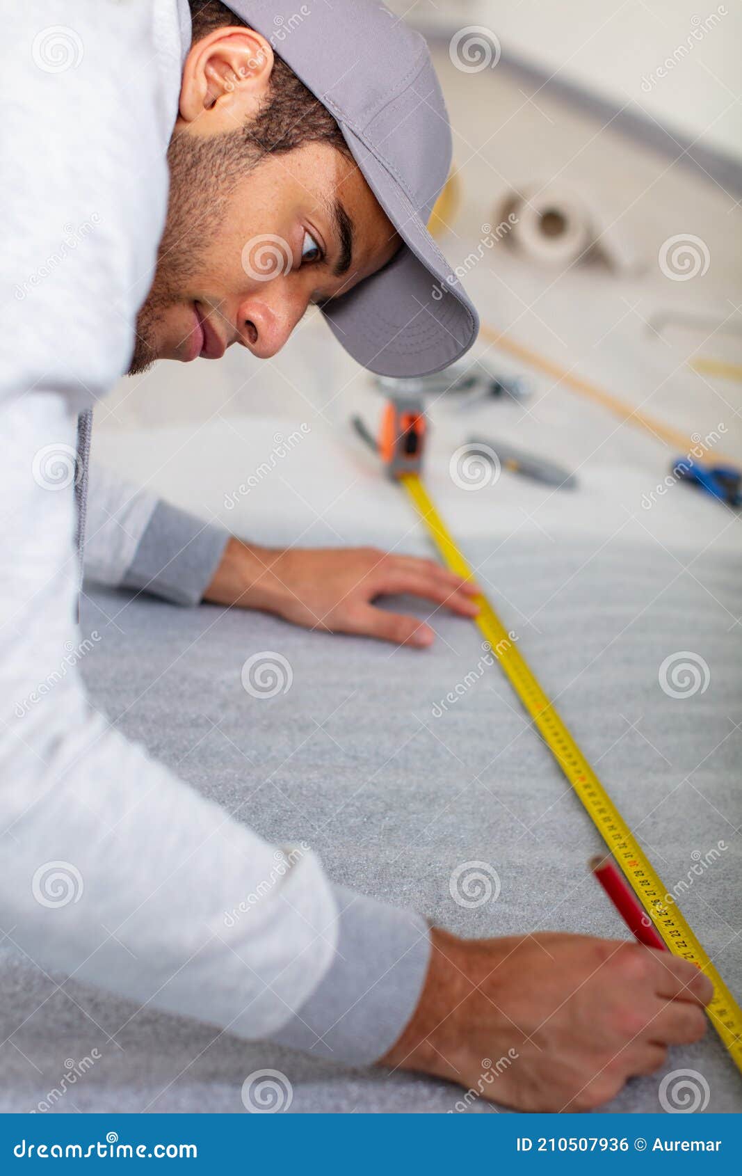 Man Using Measuring Tape on Floor Stock Photo - Image of person ...