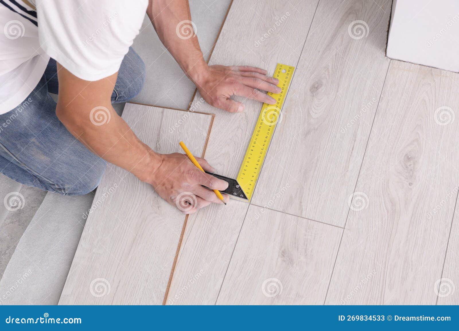 Man Using Measuring Tape during Installation of Laminate Flooring ...