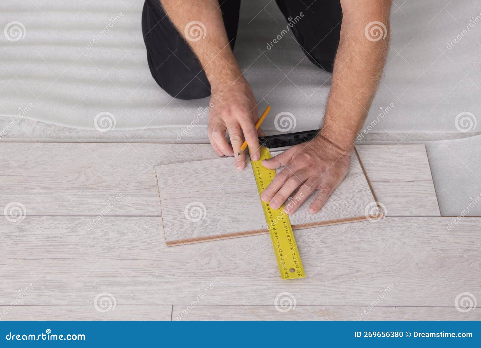 Man Using Measuring Tape during Installation of Laminate Flooring ...