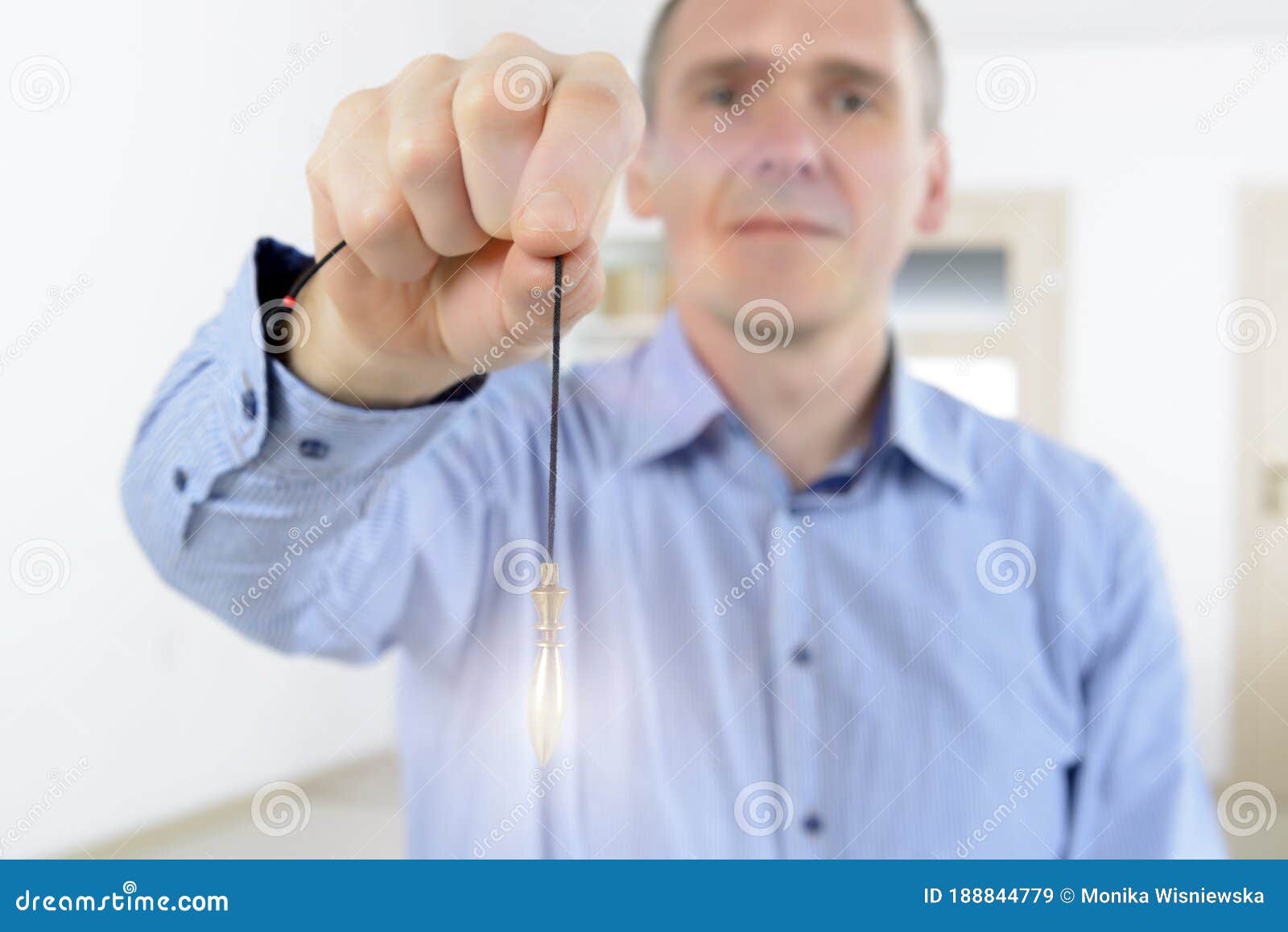 Man using metal pendulum stock image. Image of hanging - 188844779