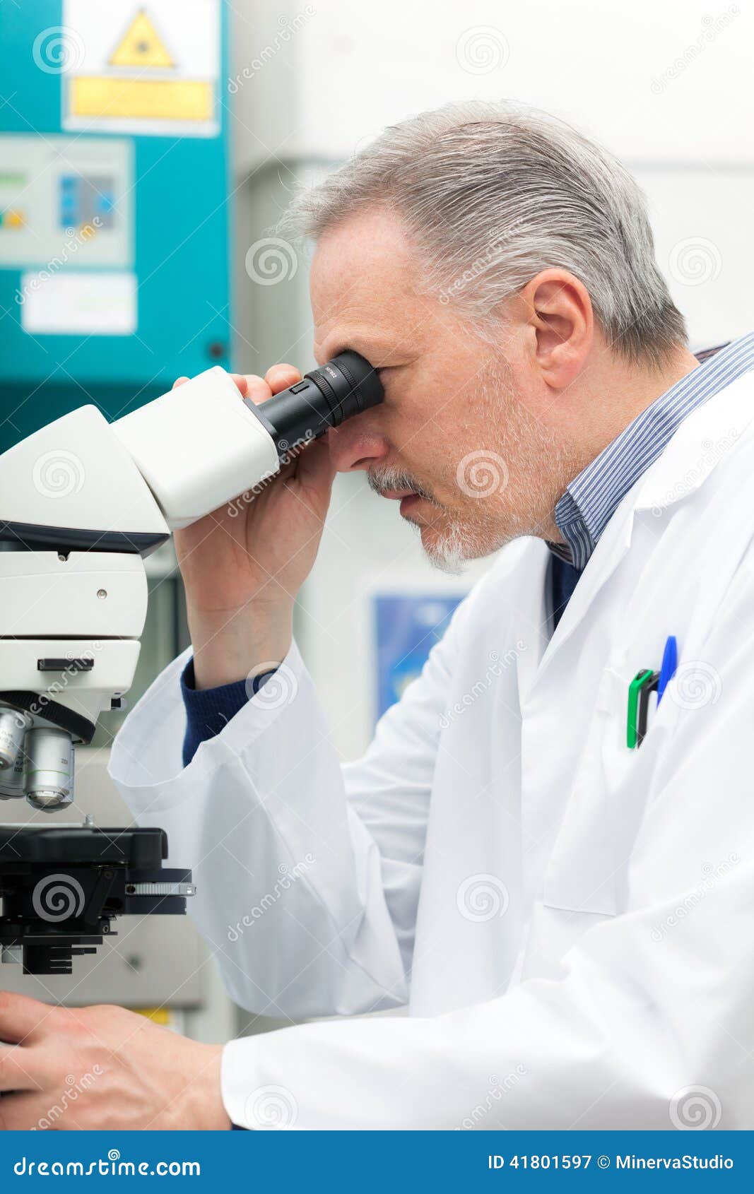 Man Using a Microscope in a Laboratory Stock Image - Image of ...