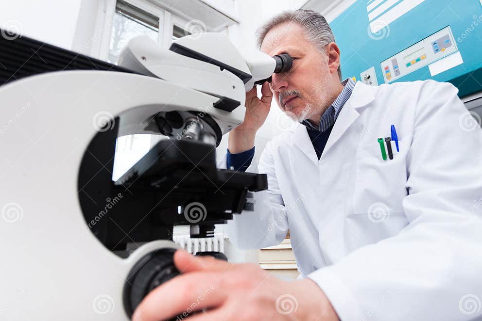 Man Using a Microscope in a Laboratory Stock Image - Image of chemistry ...